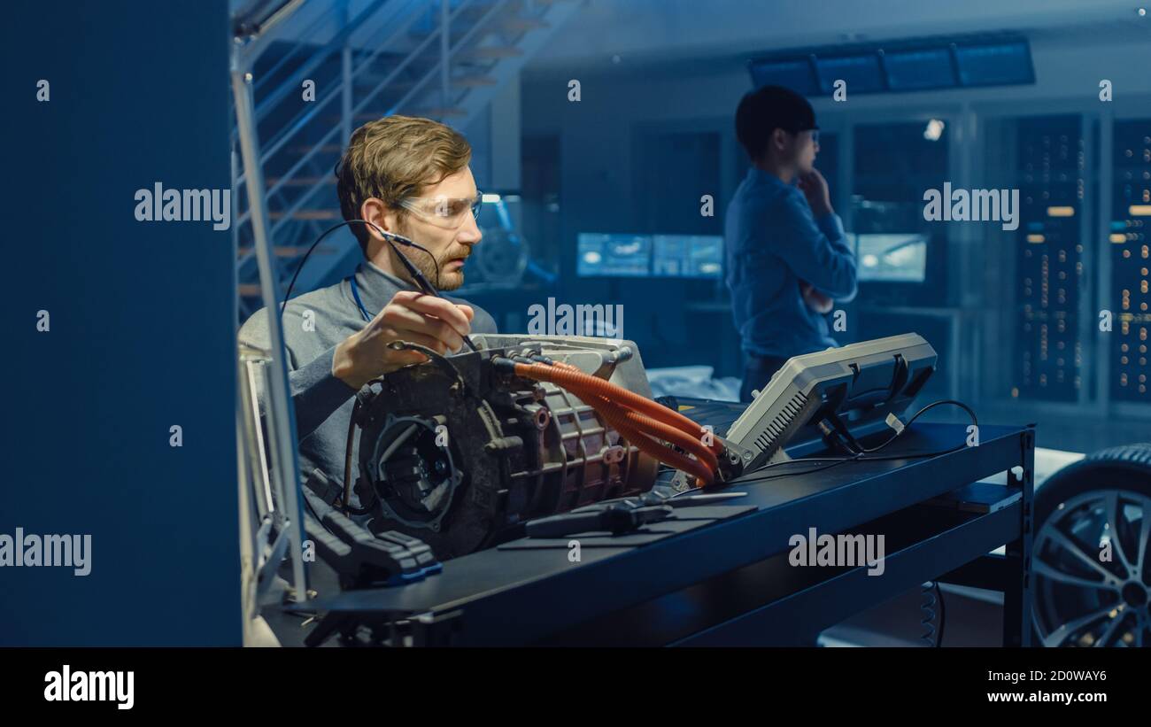 Professional Automotive Engineer in Glasses with a Computer and ...