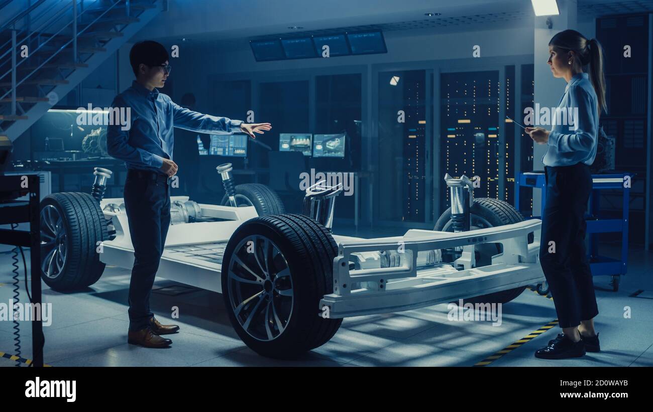 Automotive Design Engineer and Scientist with Tablet Discuss the ...