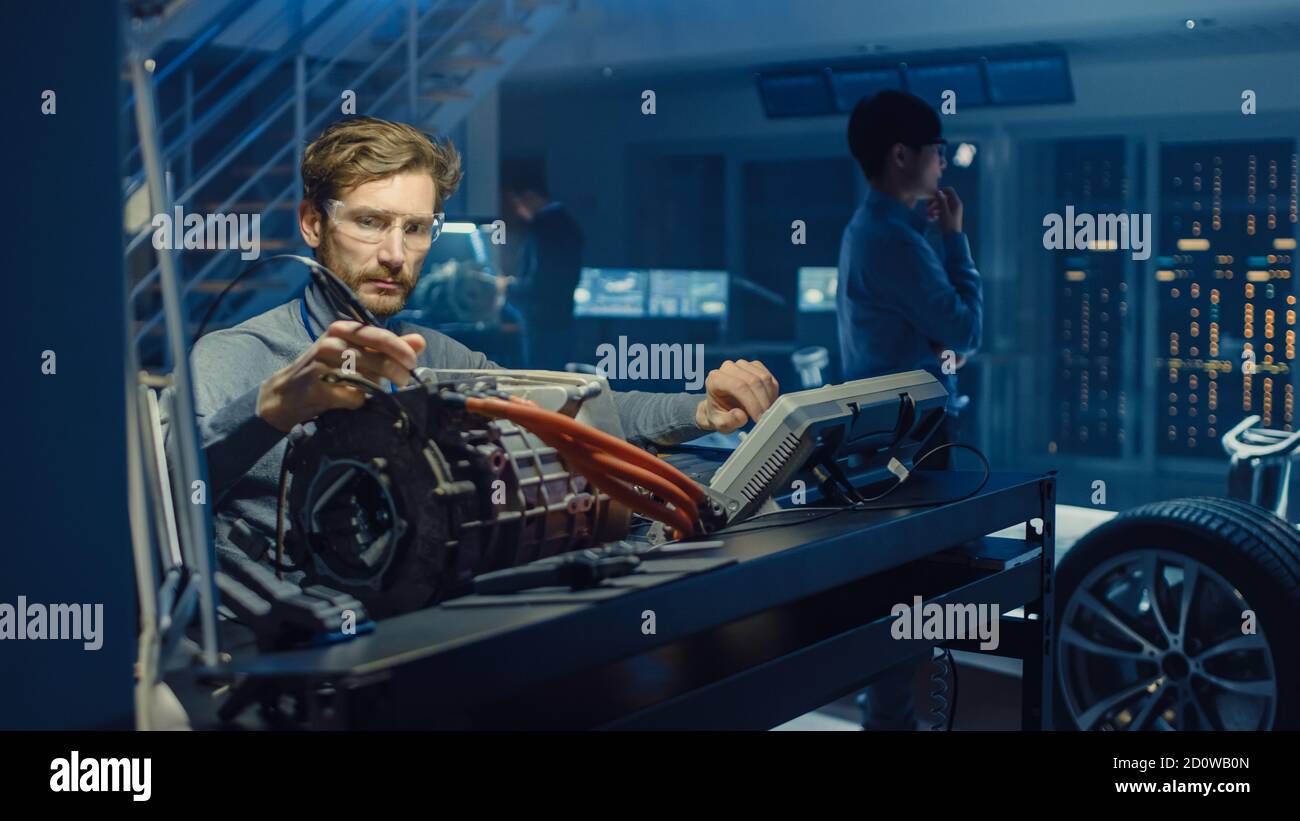Professional Automotive Engineer in Glasses with a Computer and ...