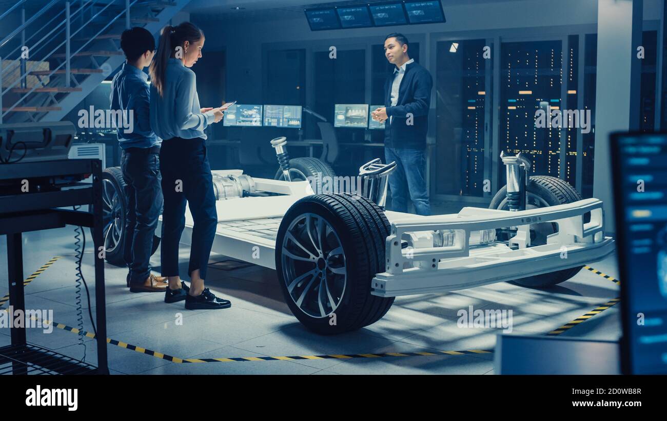 Automotive Design Engineers Talking while Working on Electric Car ...