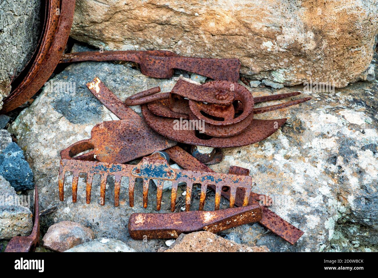 Old rusty tools for agricultural work: pickaxe, rake, pulley, hoe and ...