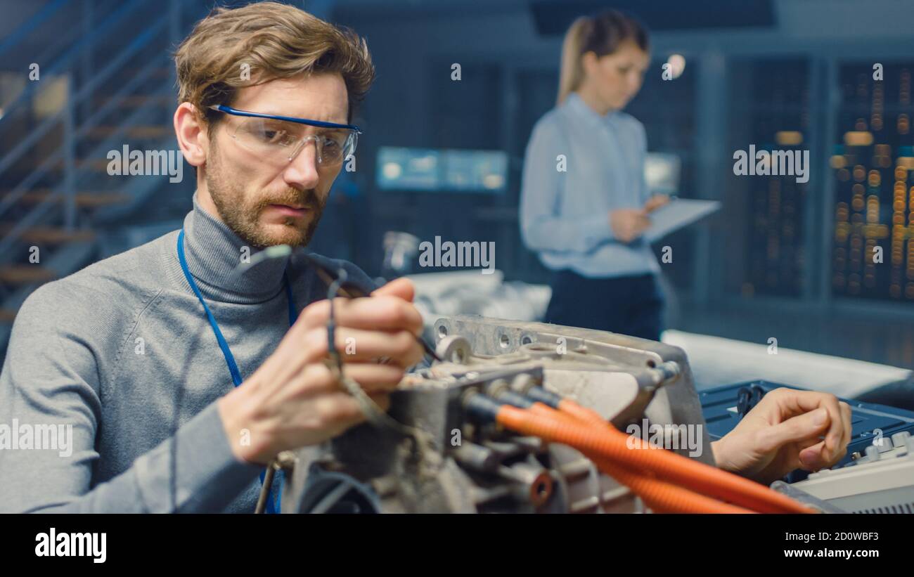 Professional Automotive Engineer in Glasses with a Computer and ...