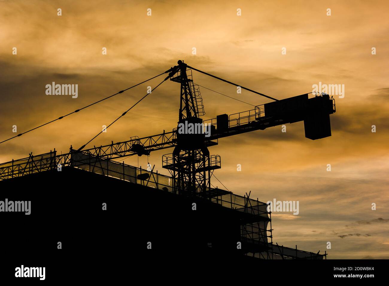 Construction crane at sunset Stock Photo - Alamy