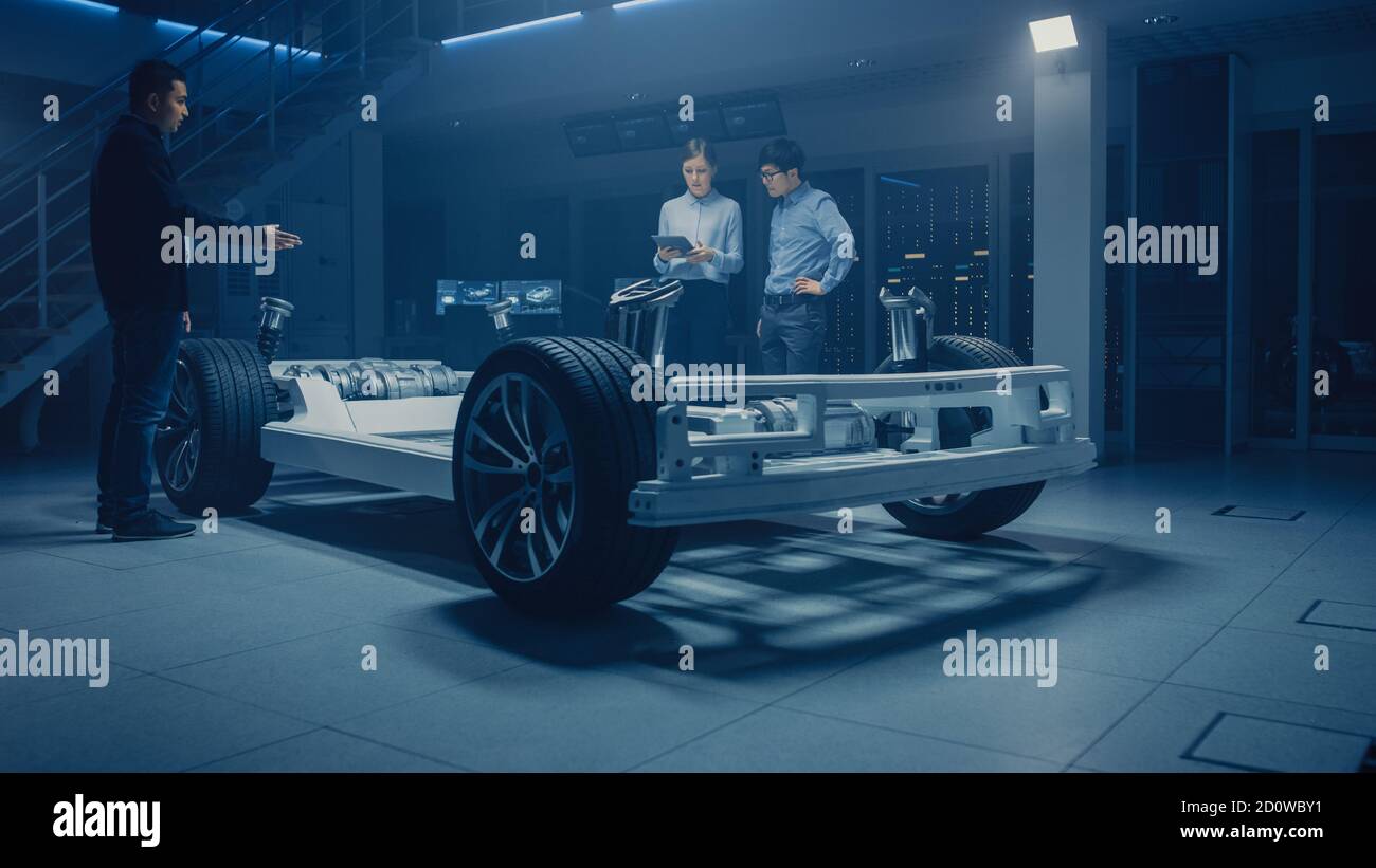 Automobile Design Engineers Talking while Working on Electric Car ...