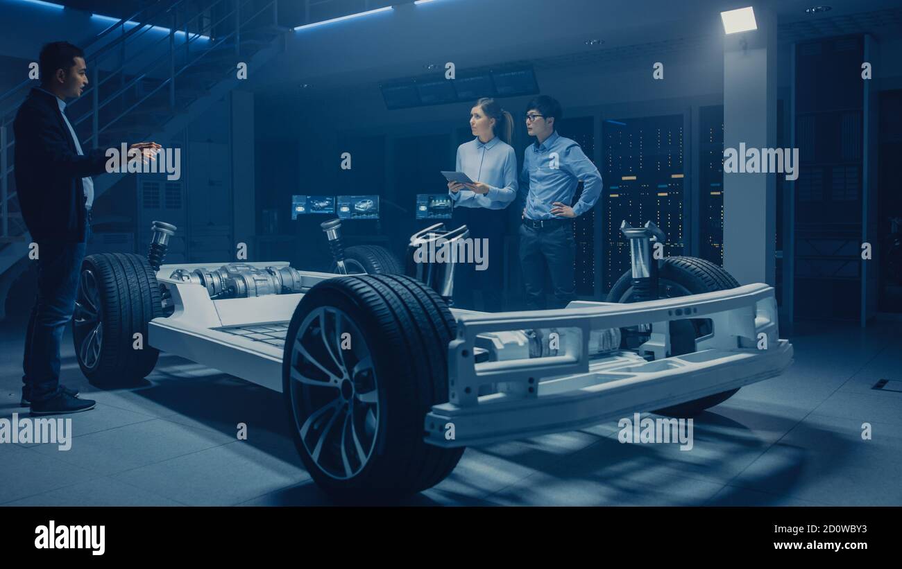 Automobile Design Engineers Talking while Working on Electric Car ...