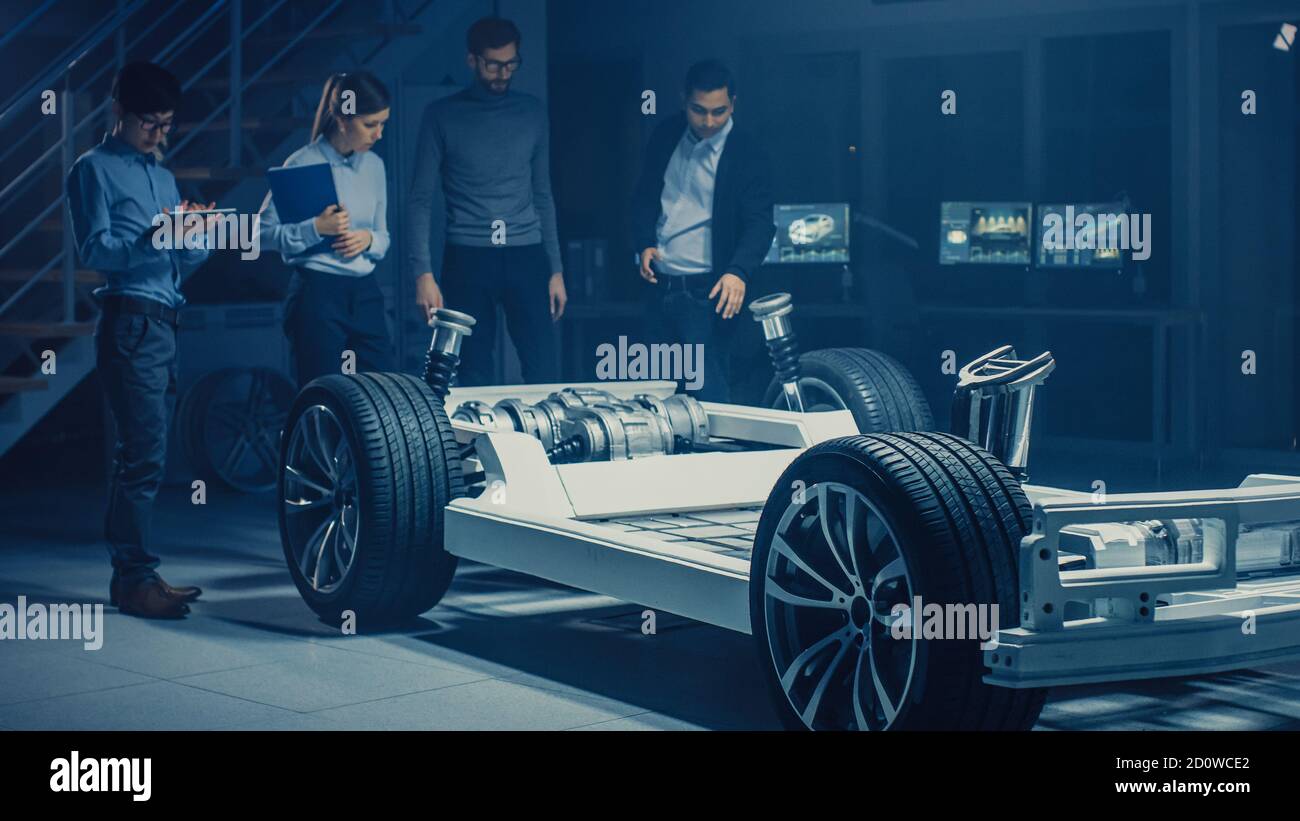 Team of Automotive Engineers Discussing and Designing Electric Car ...