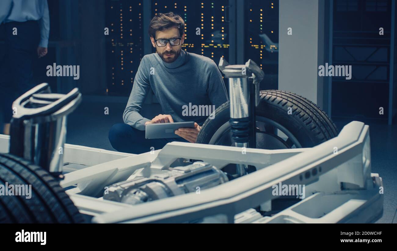 Automobile Design Engineer Sitting Beside Hybrid Electric Car Chassis ...