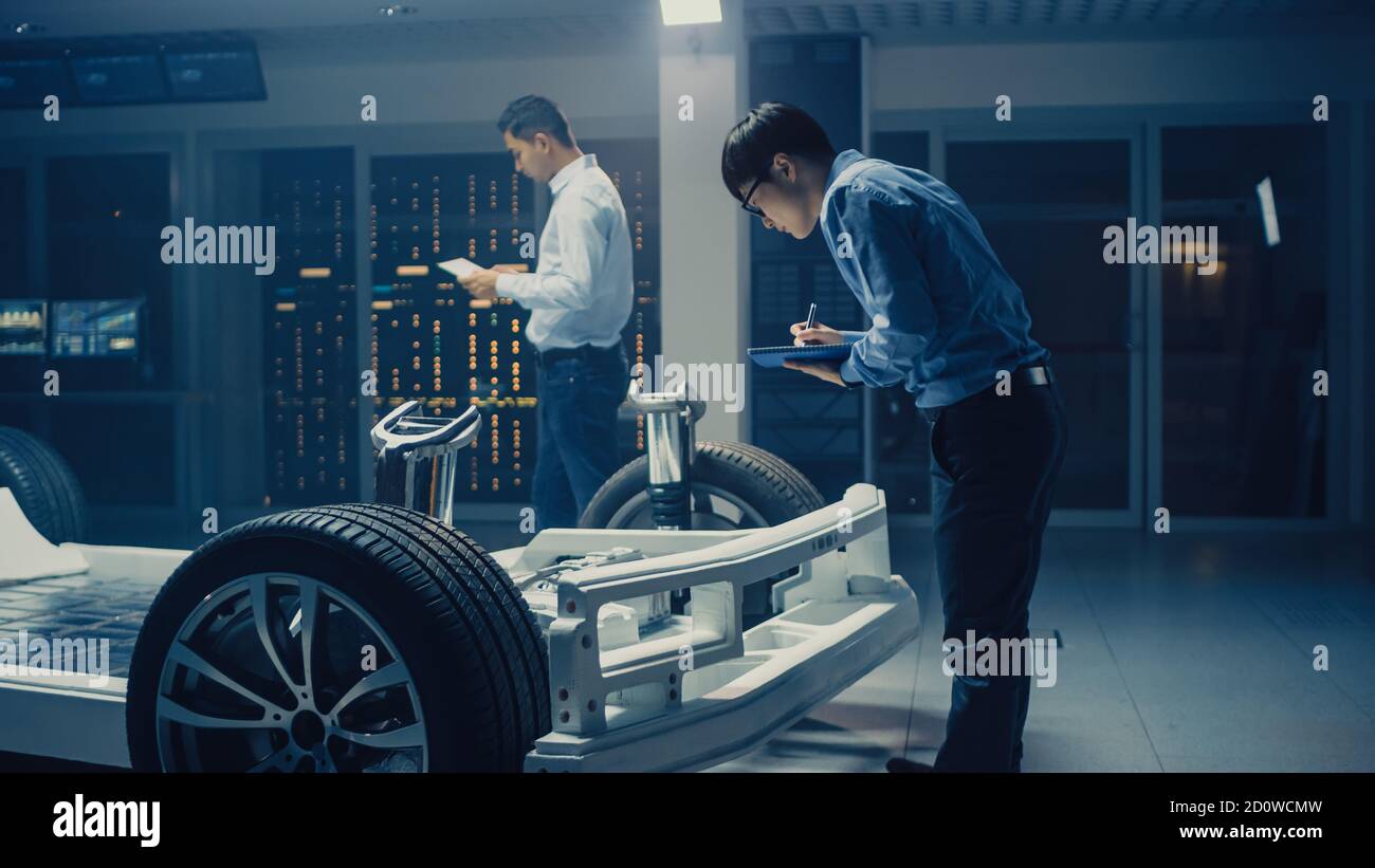 Automotive Engineers Working on Electric Car Chassis Platform, Taking ...