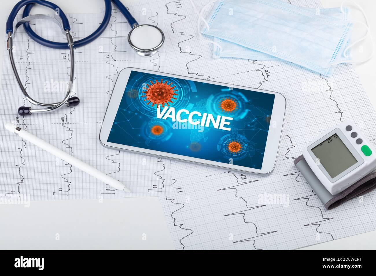 Close-up view of a tablet pc with VACCINE inscription, microbiology ...