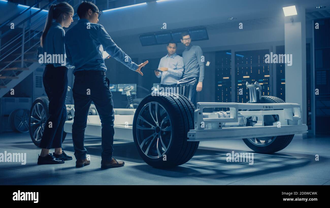 Team of Automotive Engineers Discussing and Designing Electric Car ...