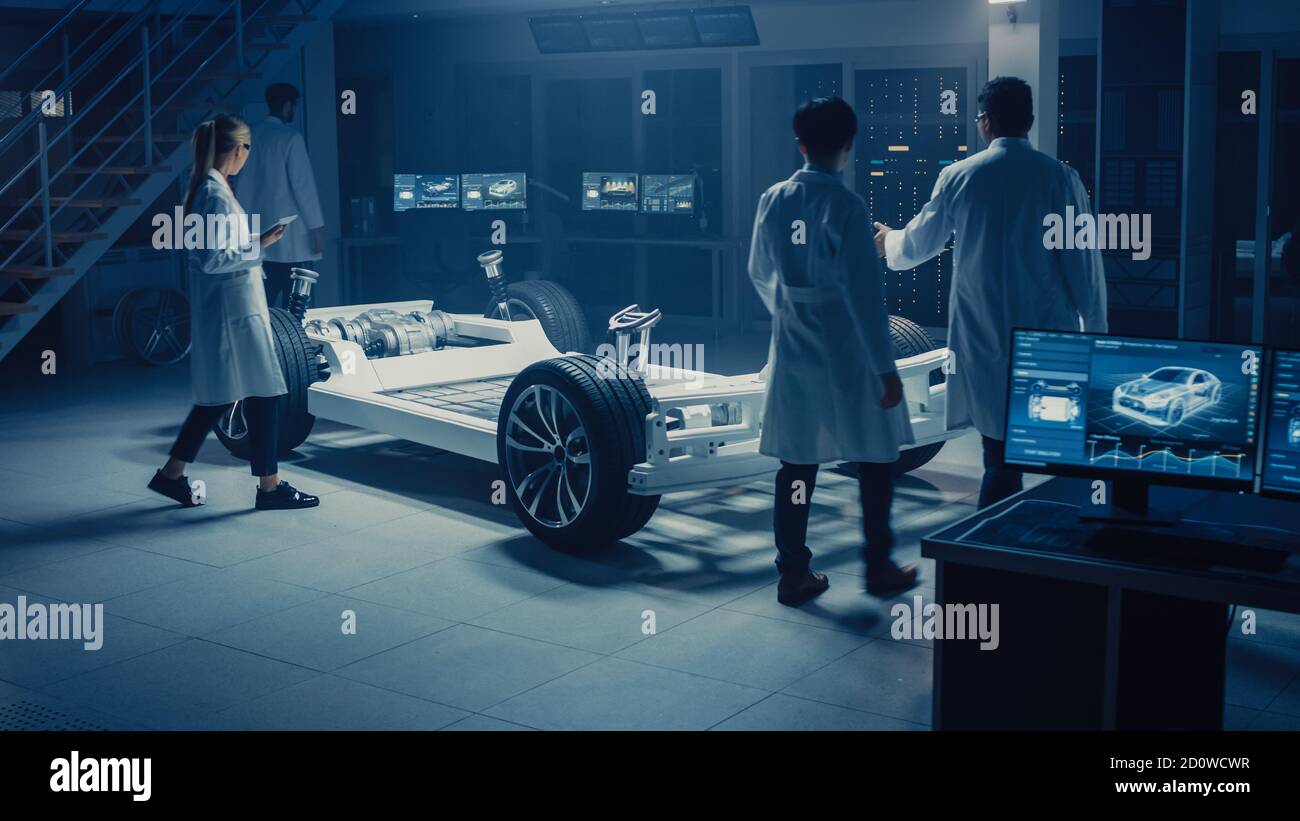 Team of Automotive Engineers and Scientists Discussing, Designing and ...
