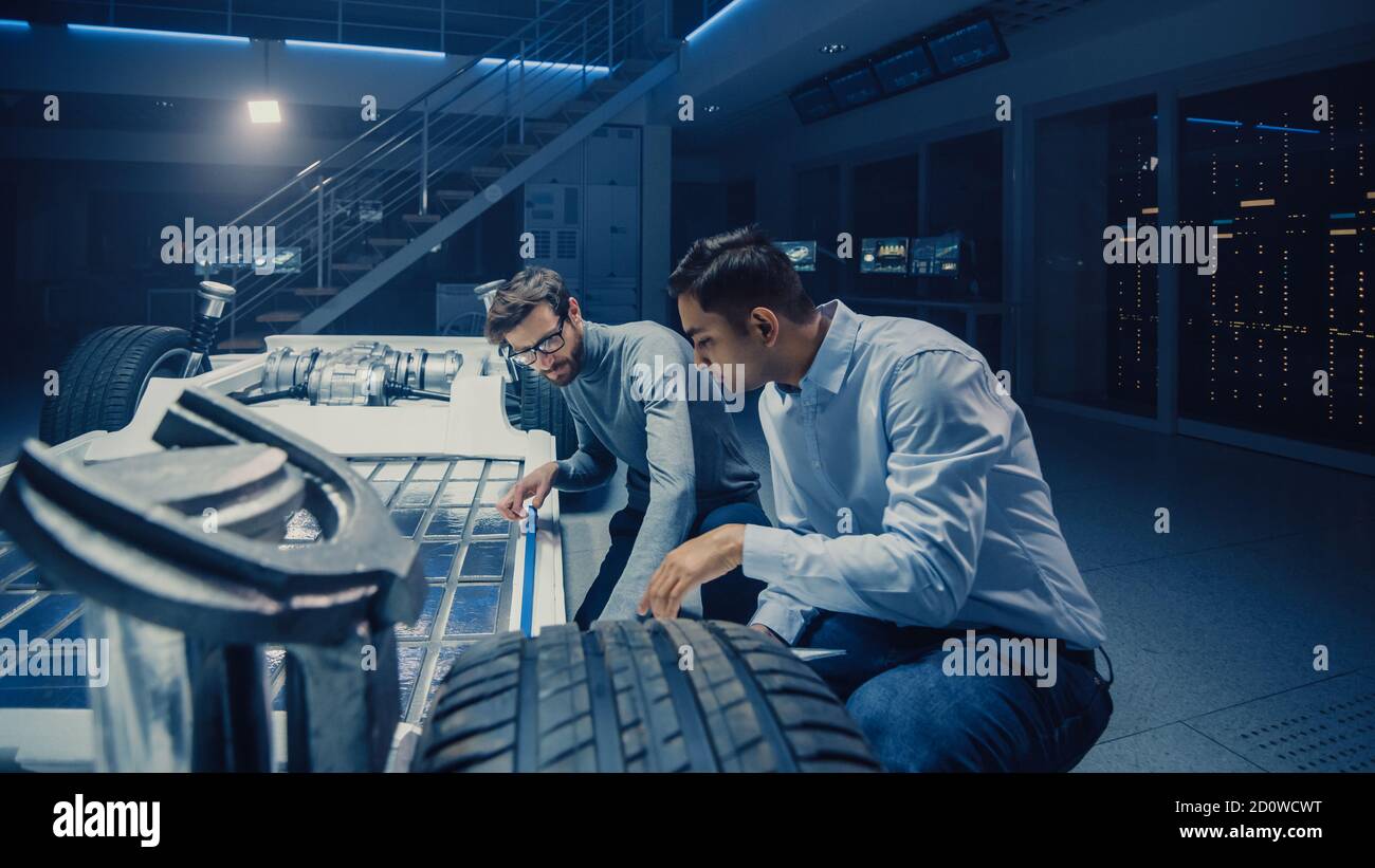 Two Automotive Engineers Working on Electric Car Chassis Platform ...