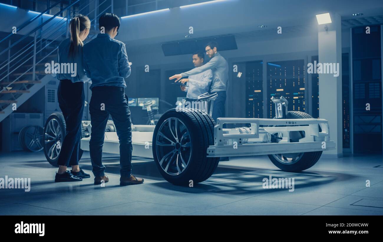 Team of Automotive Engineers Discussing and Designing Electric Car ...