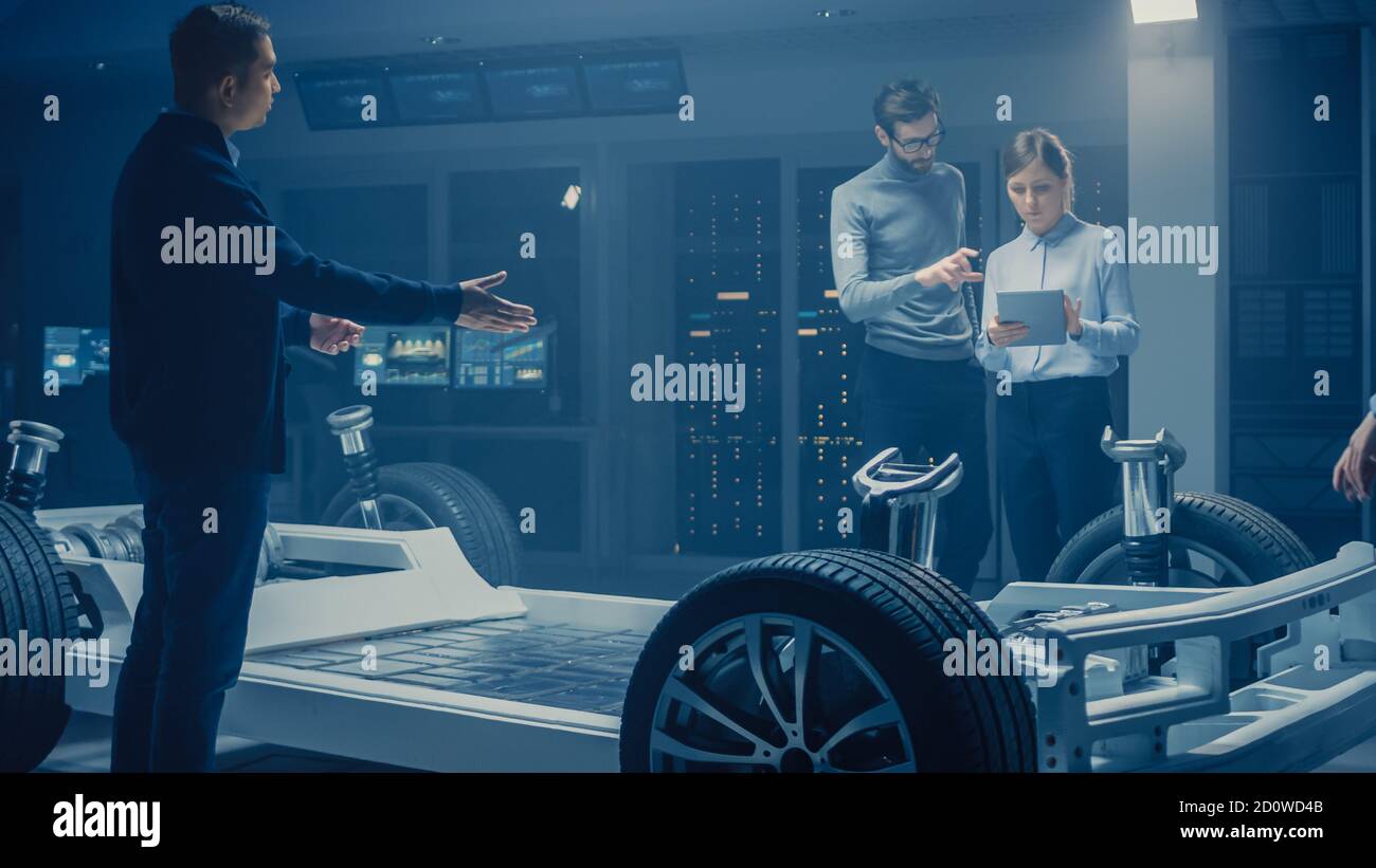 Automobile Engineers Discussing and Designing Electric Car Chassis ...