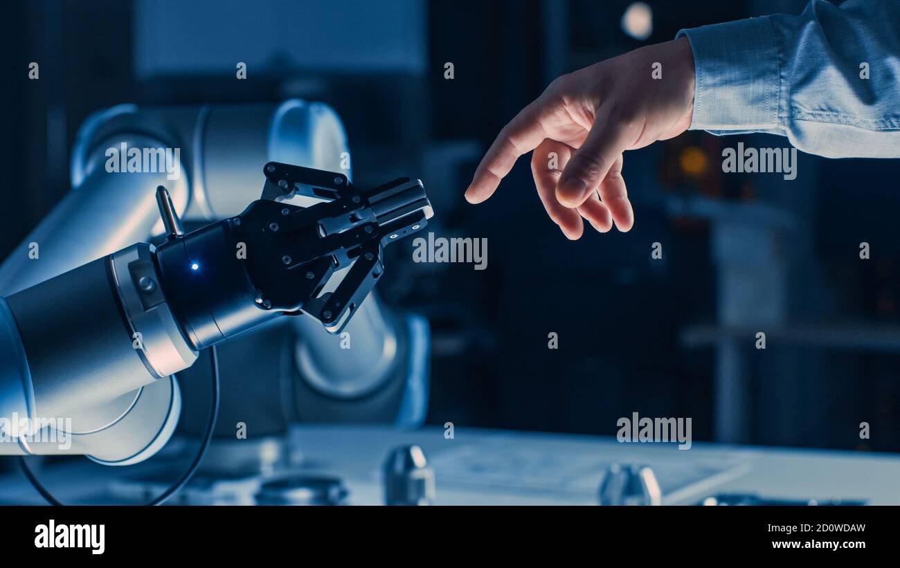 Futuristic Robot Arm Touches Human Hand in Humanity and Artificial Intelligence Unifying Gesture ...