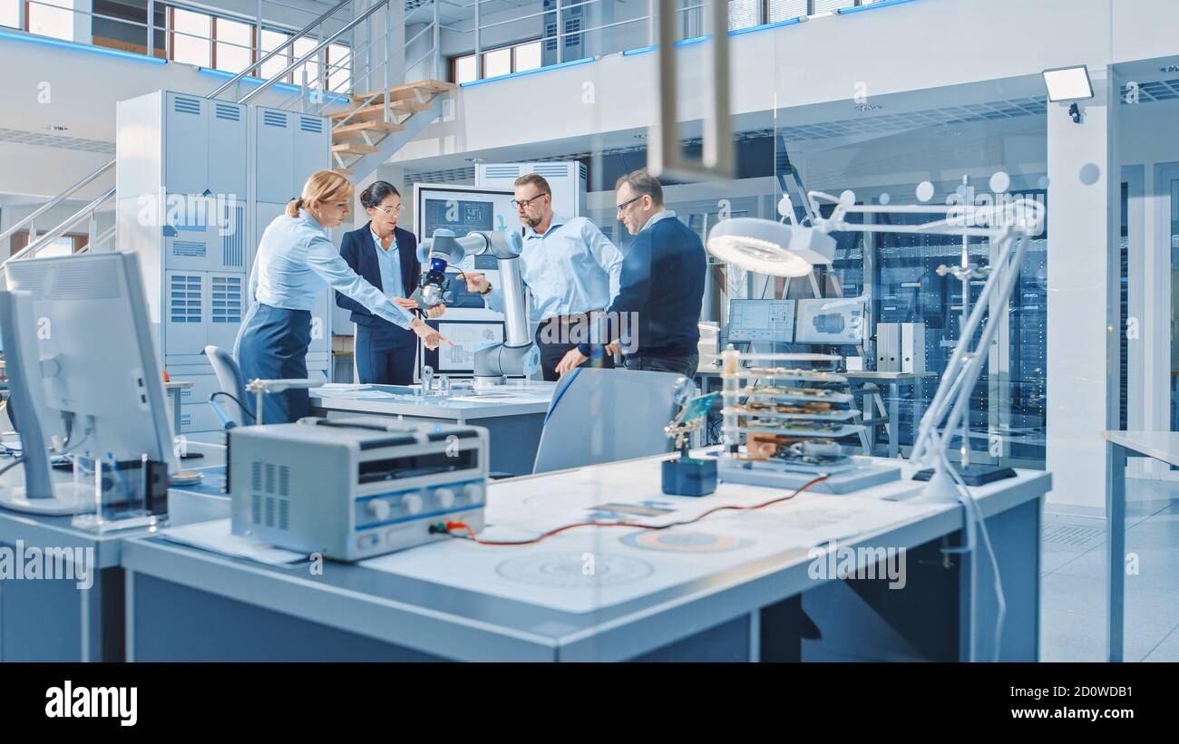 Diverse Team of Industrial Robotics Design Engineers Gathered Around ...