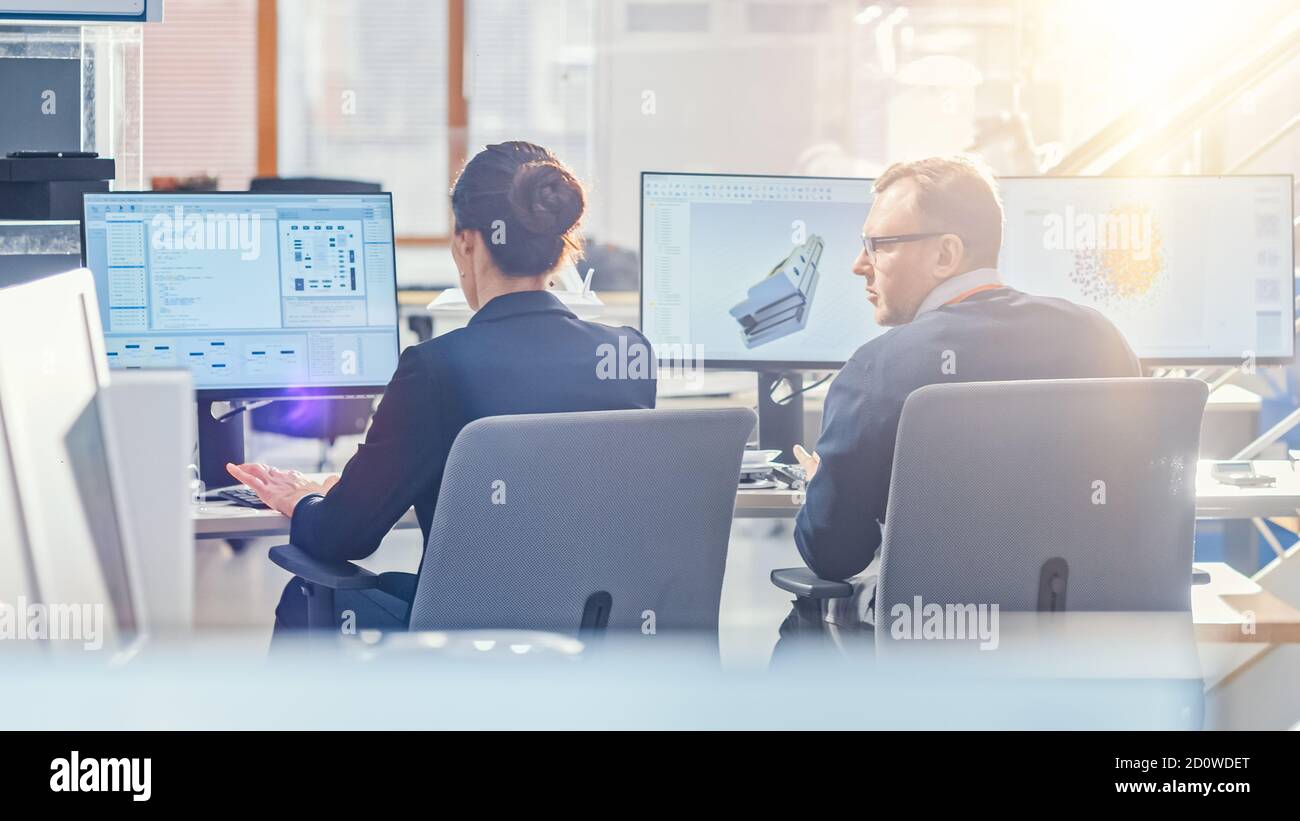 Back View of Team of Technology Engineers Working on Desktop Computers ...