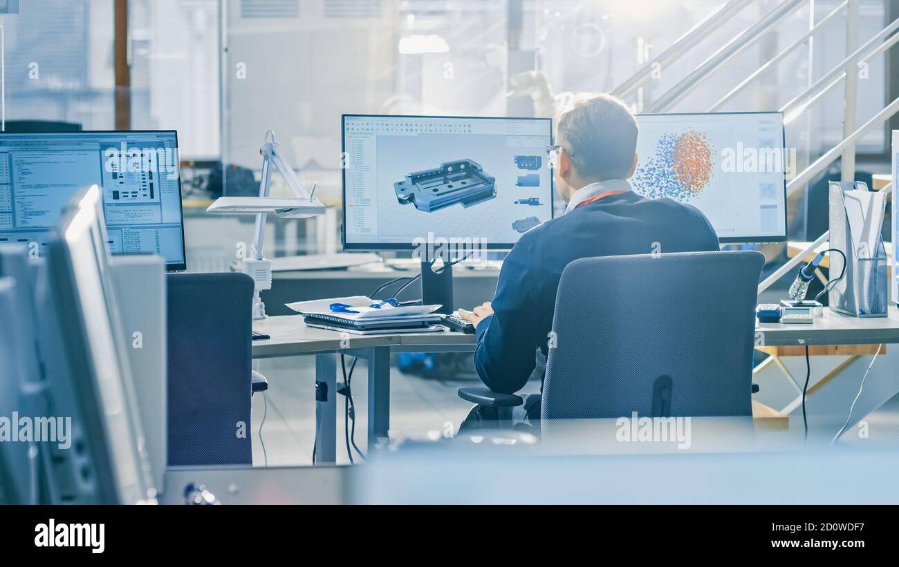 Back View of Industrial Engineer Working on Desktop Computer in Bright ...