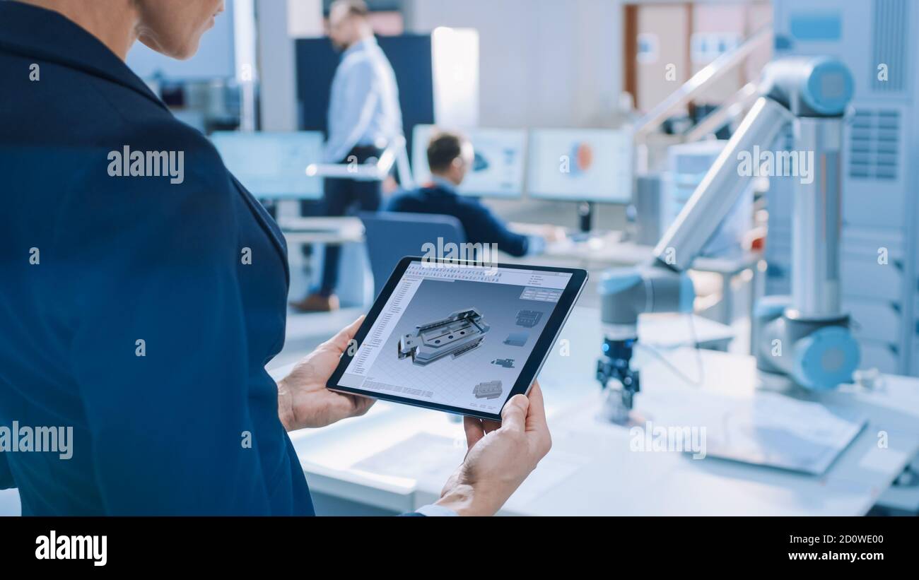 Stylish Female Industrial Robotics Engineer Uses Tablet Computer with ...