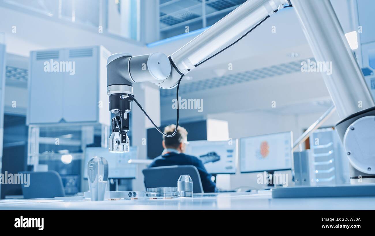 Modern Robot Arm Picks up, Lifts and Moves Metal Component as ...