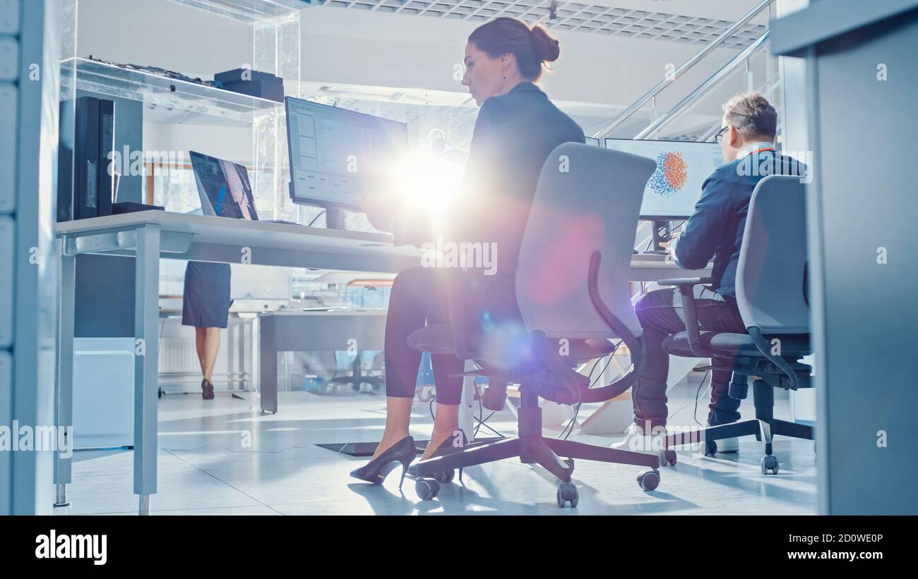 Back View of Team of Technology Engineers Working on Desktop Computers ...