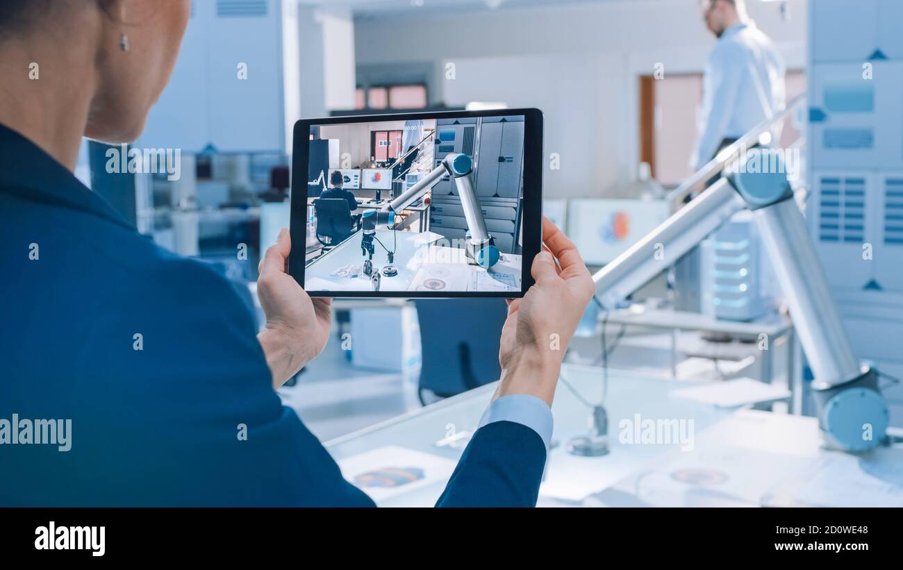 Stylish Female Industrial Robotics Engineer Uses Tablet Computer ...