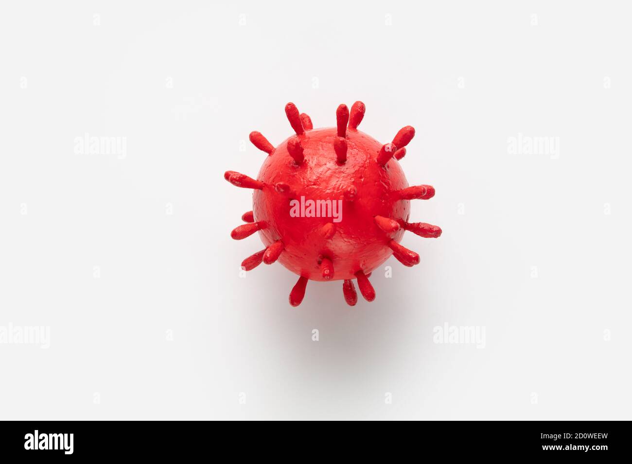 A photograph of a large red virus sculpture. The artwork inspired by ...