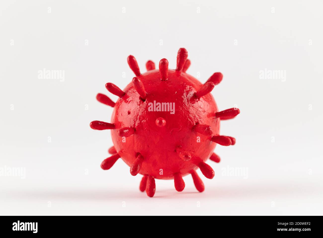 A photograph of a large red virus sculpture. The artwork inspired by ...