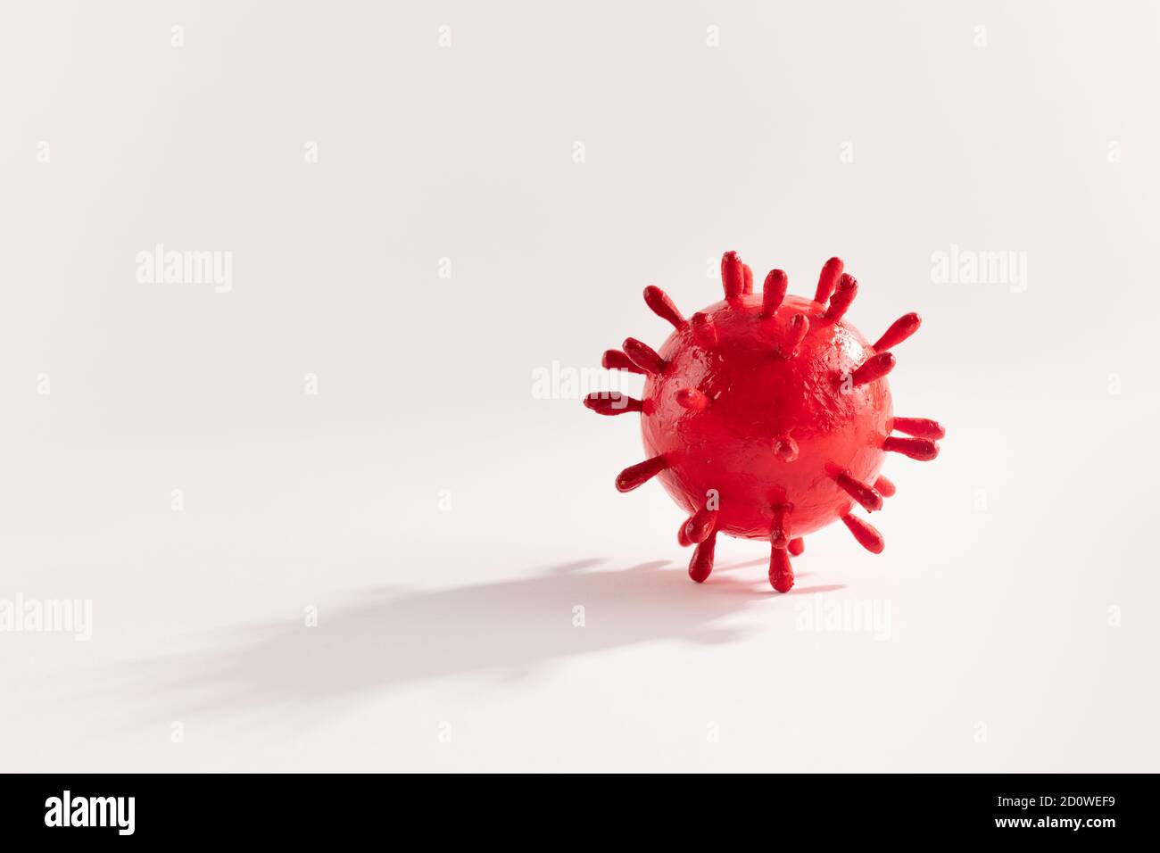 A photograph of a large red virus sculpture. The artwork inspired by ...