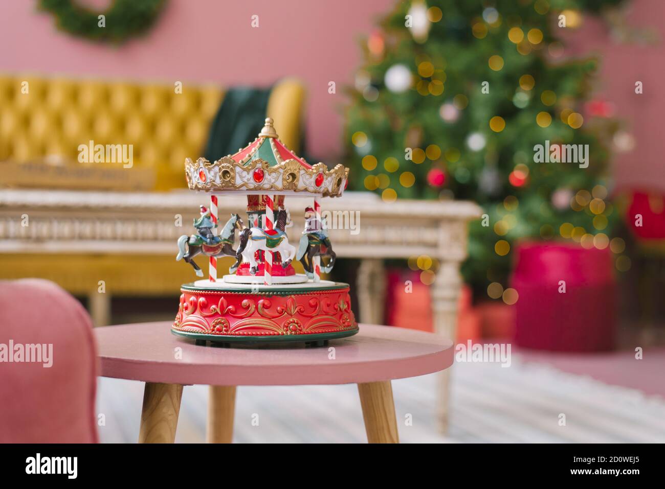 Christmas carousel gift with blurred background, tree and colorful ...