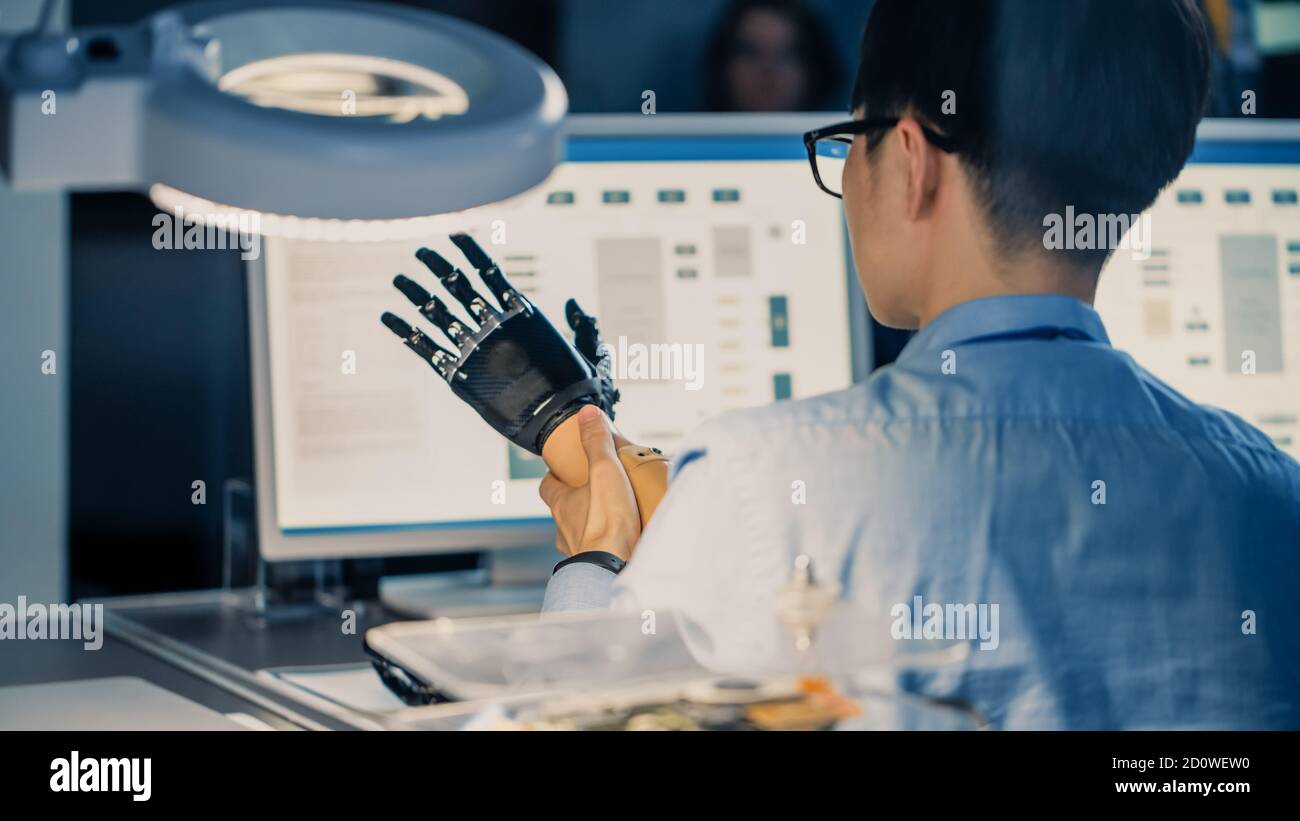 Close Up of a Futuristic Prosthetic Robot Arm Being Tested by a ...