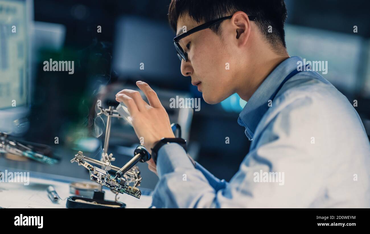 Professional Japanese Electronics Development Engineer in Blue Shirt is ...