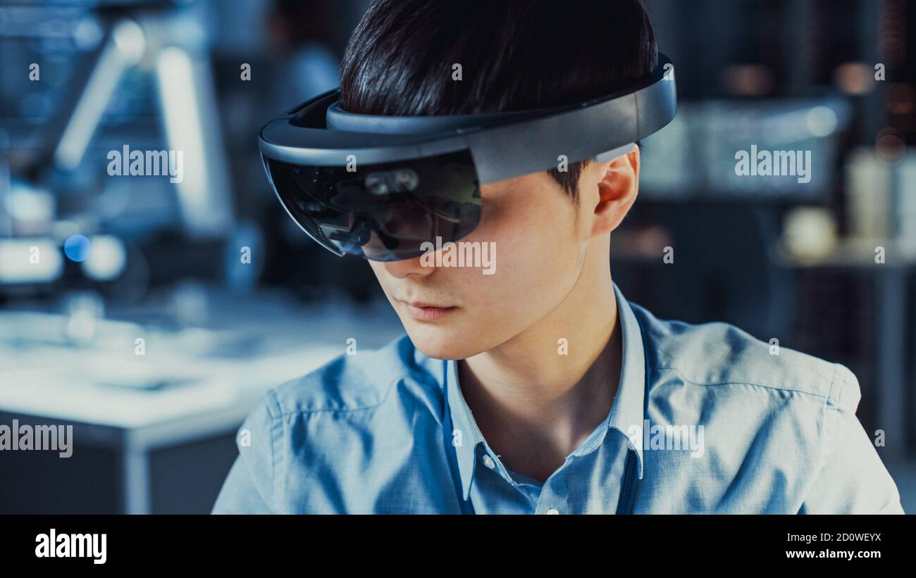 Professional Japanese Electronics Development Engineer in Blue Shirt is Wearing a Virtual ...