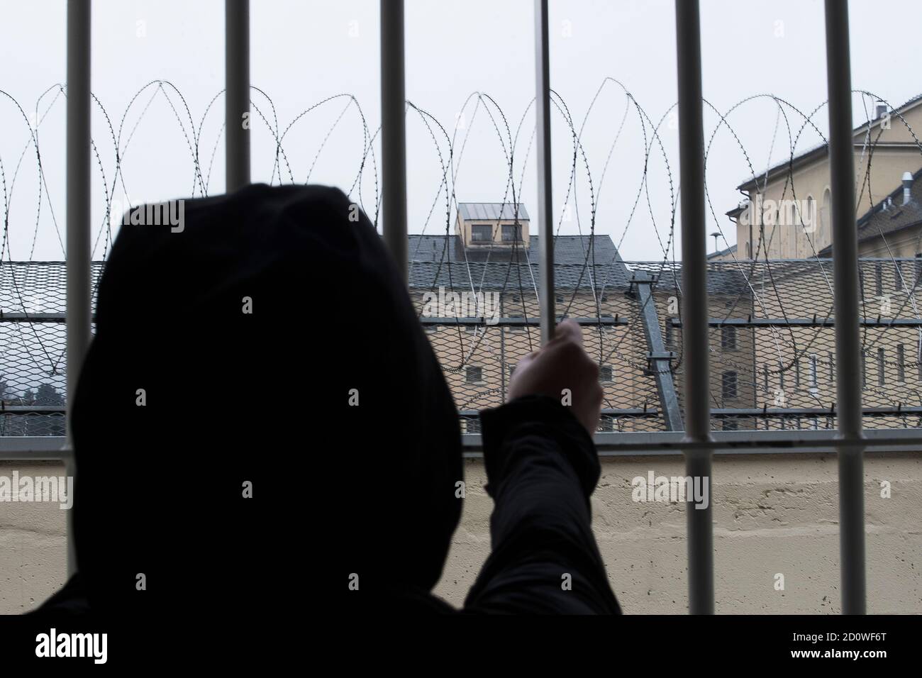 prisoner looking out of the window of a prison cell Stock Photo - Alamy