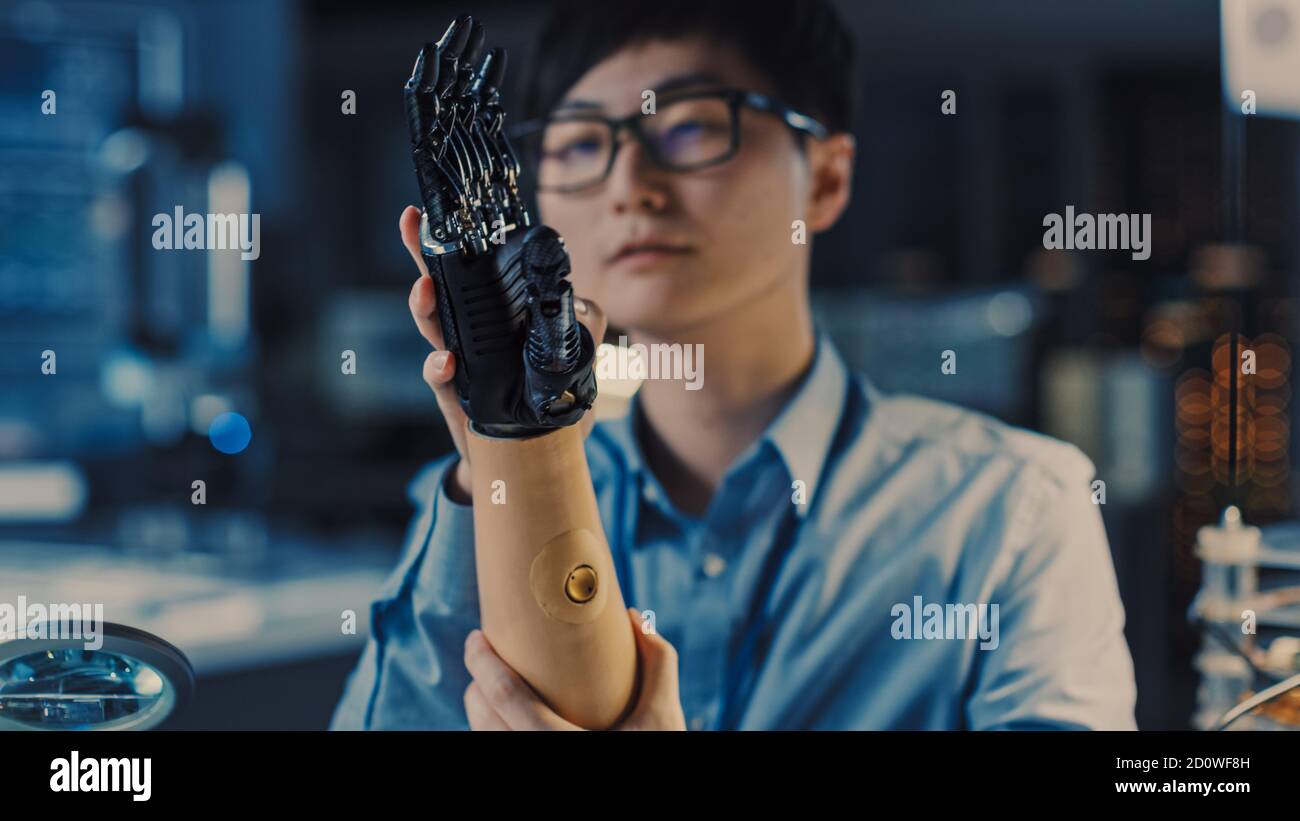 Close Up of a Futuristic Prosthetic Robot Arm Being Tested by a ...