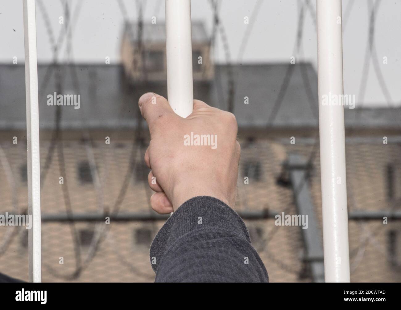 prisoner looking out of the window of a prison cell Stock Photo - Alamy