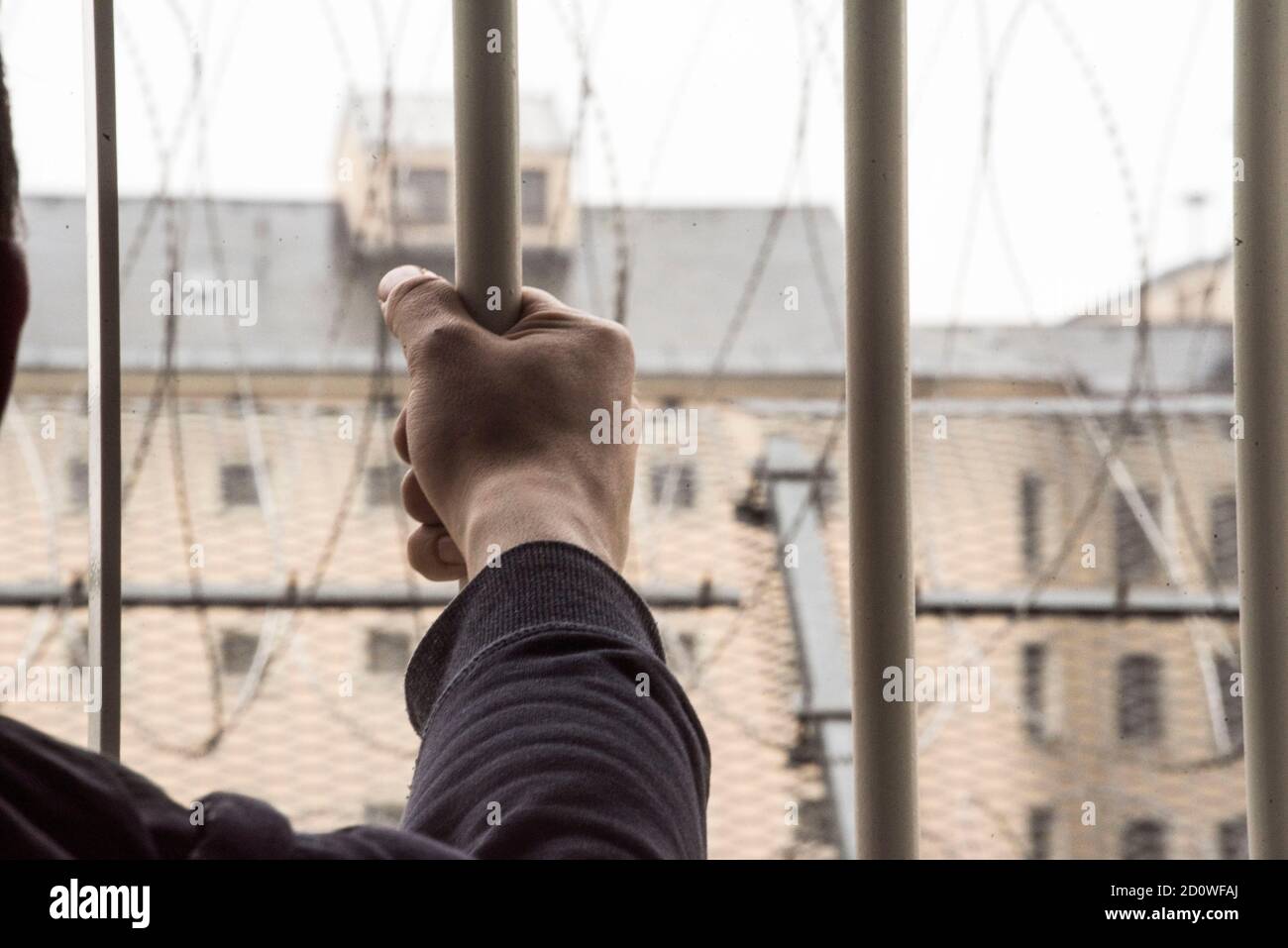 prisoner looking out of the window of a prison cell Stock Photo - Alamy