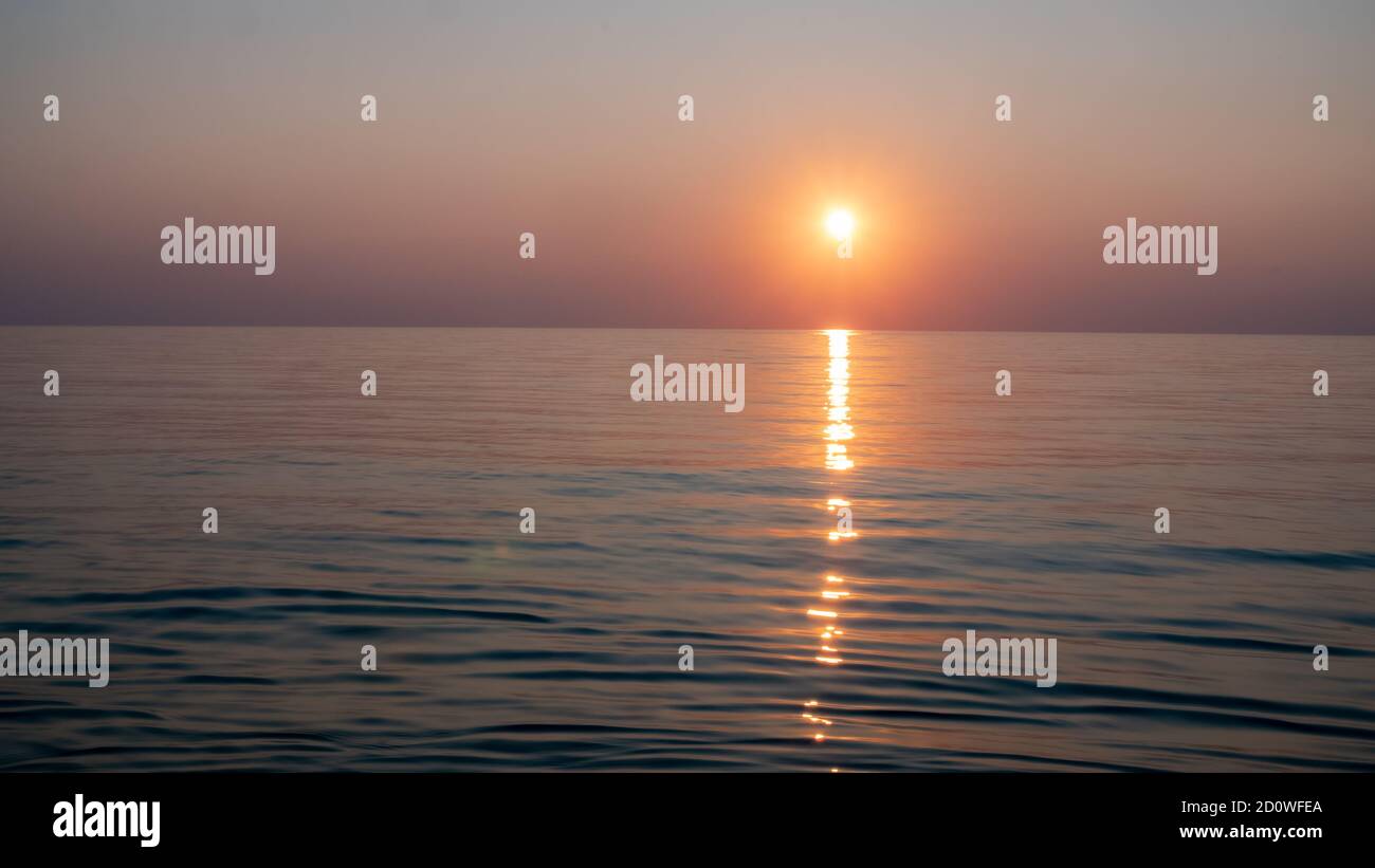 Stunning sunset view with a reflection on a seawater Stock Photo - Alamy