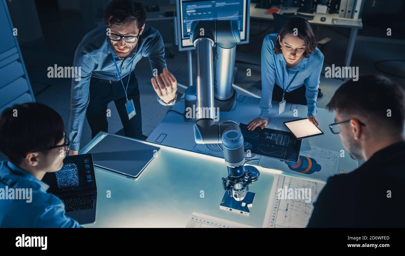 Futuristic Robotic Arm Picking Up a Metal Object and Moving It. Senior ...