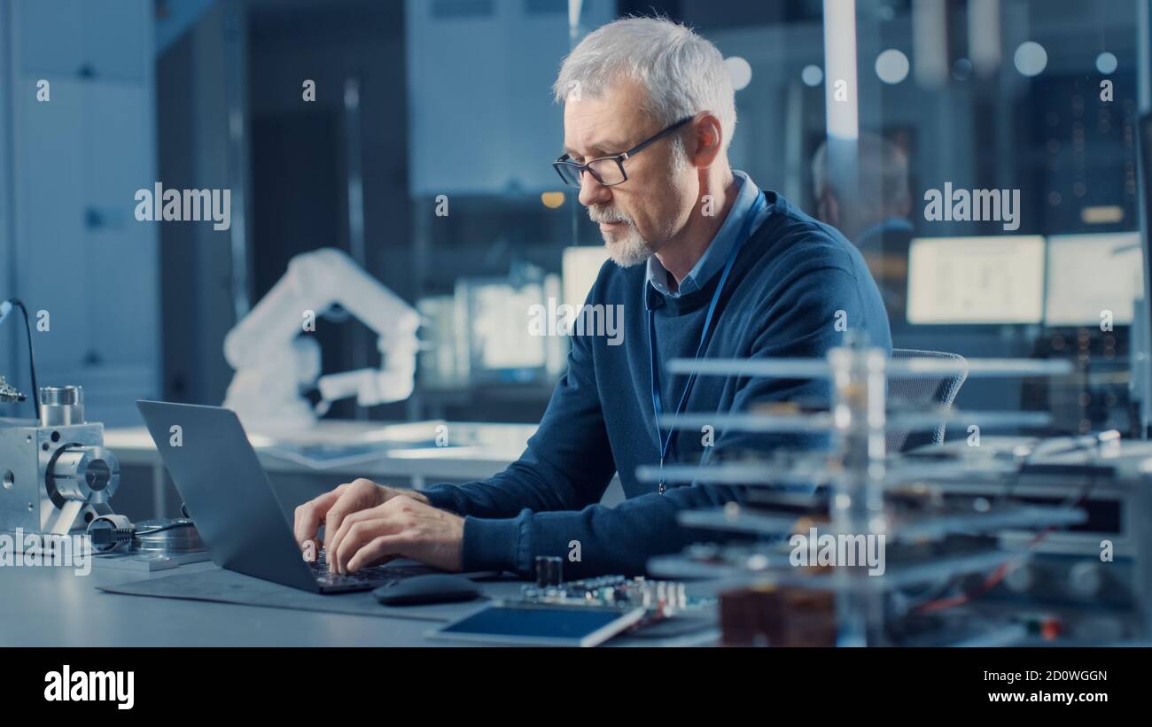 Professional Electronics Design Engineer Wearing Glasses Works on ...