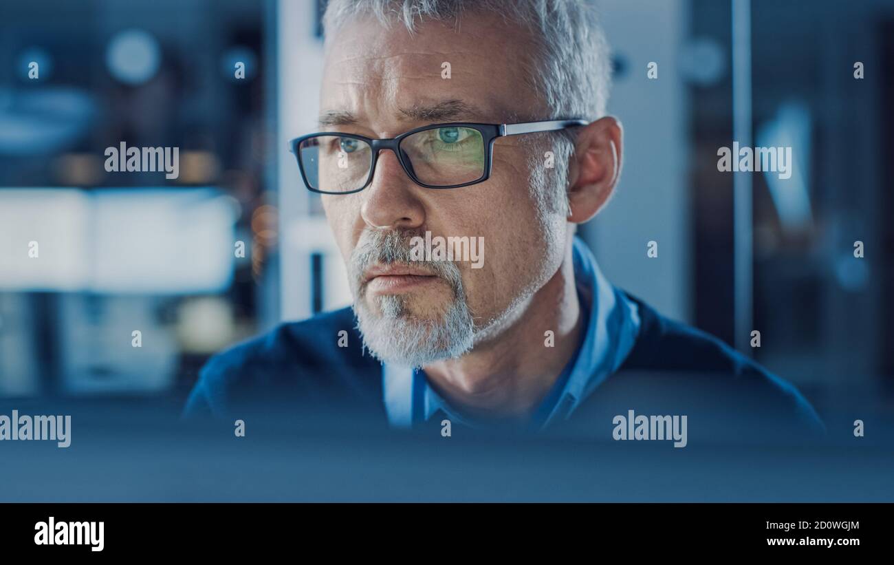 Portrait of Handsome Middle Aged Engineer Wearing Glasses Works on ...