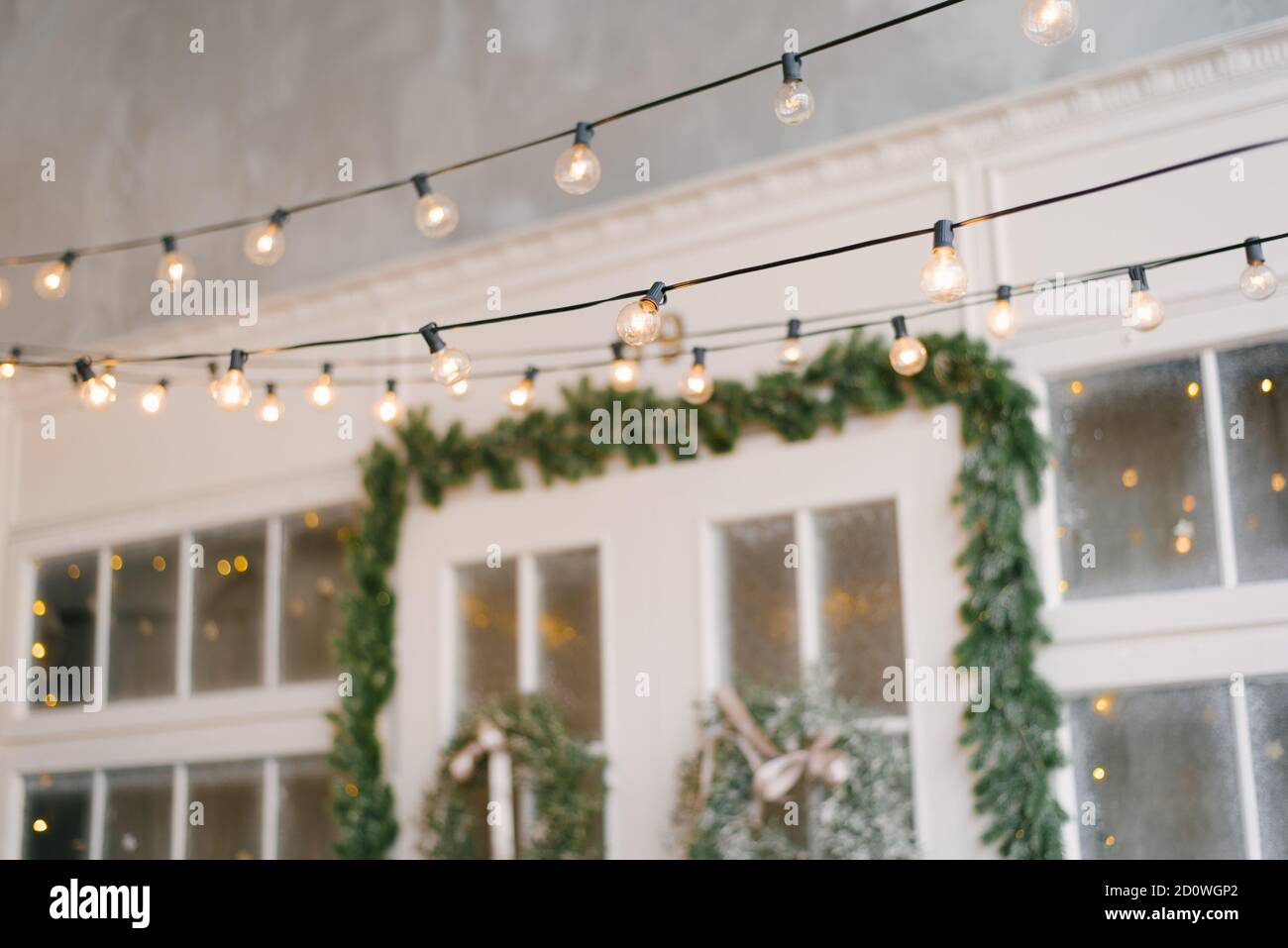 A retro garland of incandescent lamps is lit against the background of ...