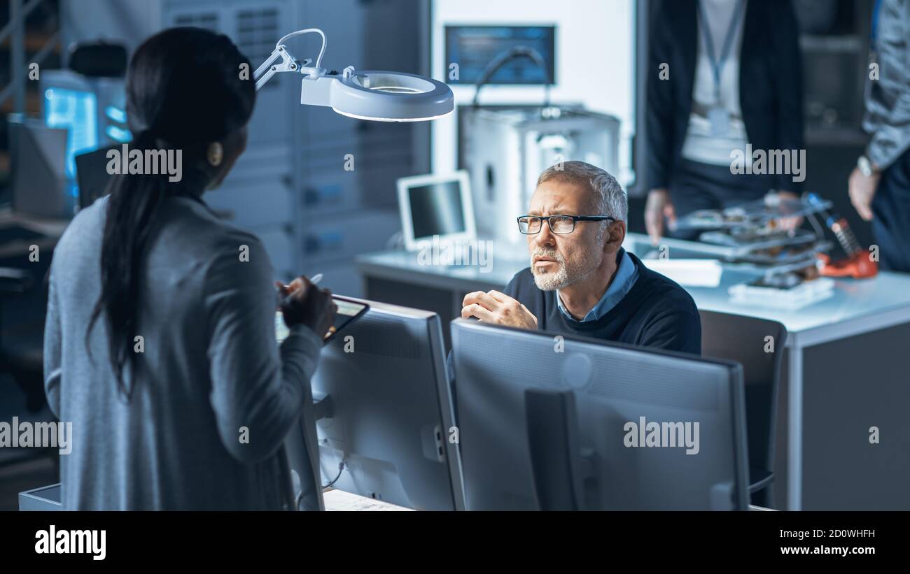 Shot of Male Industrial Engineer Talking with Female Manager about New ...