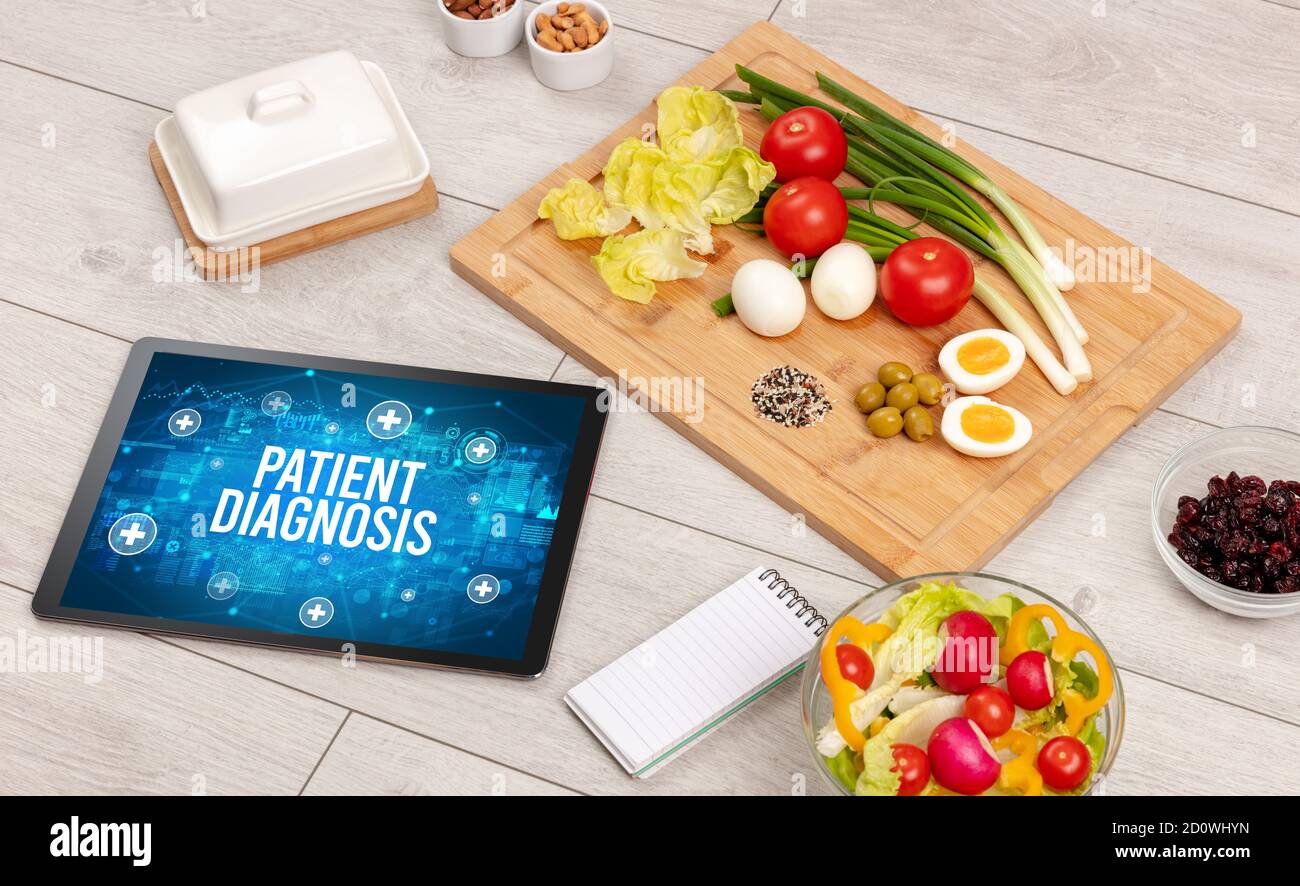 PATIENT DIAGNOSIS concept in tablet pc with healthy food around, top ...