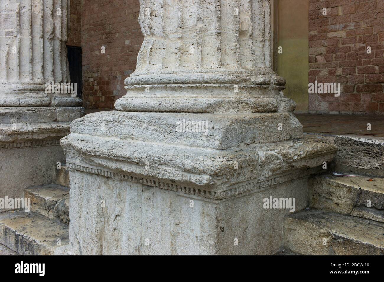 Old weathered and damaged historic basement of Tuscan columns and a ...