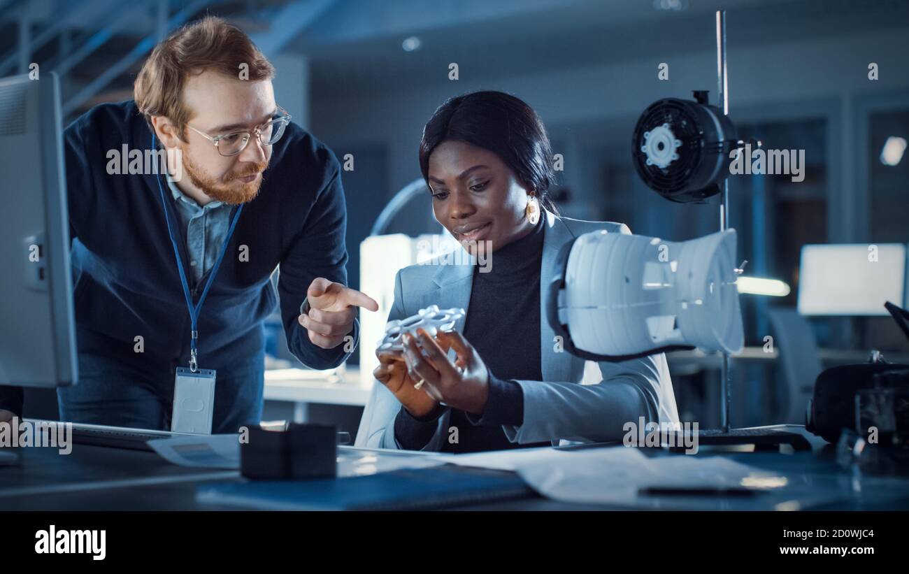 Electronics Development Engineer Working at His Desk, Talks with ...