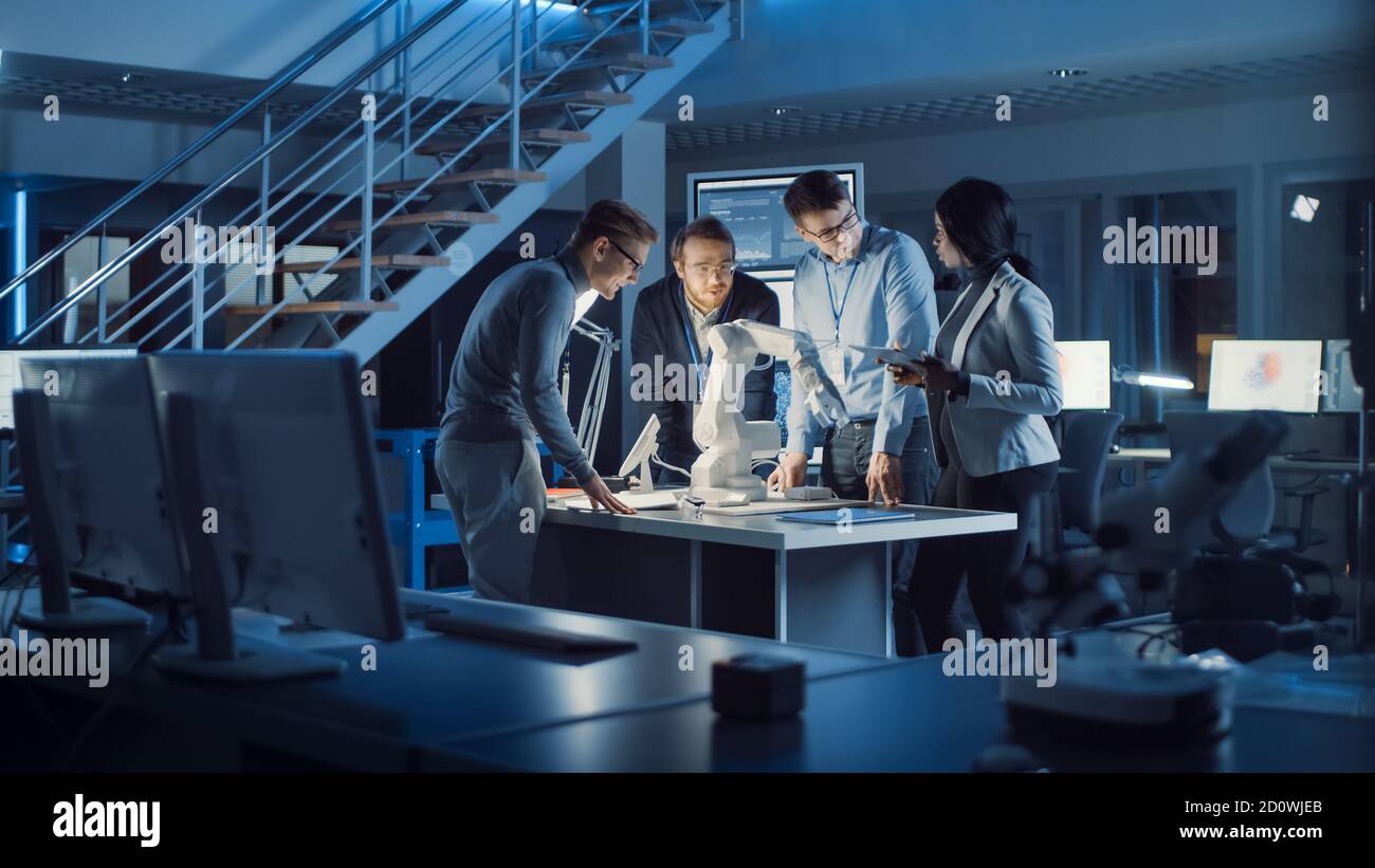 Team of Electronics Development Engineers Standing at the Desk Working ...