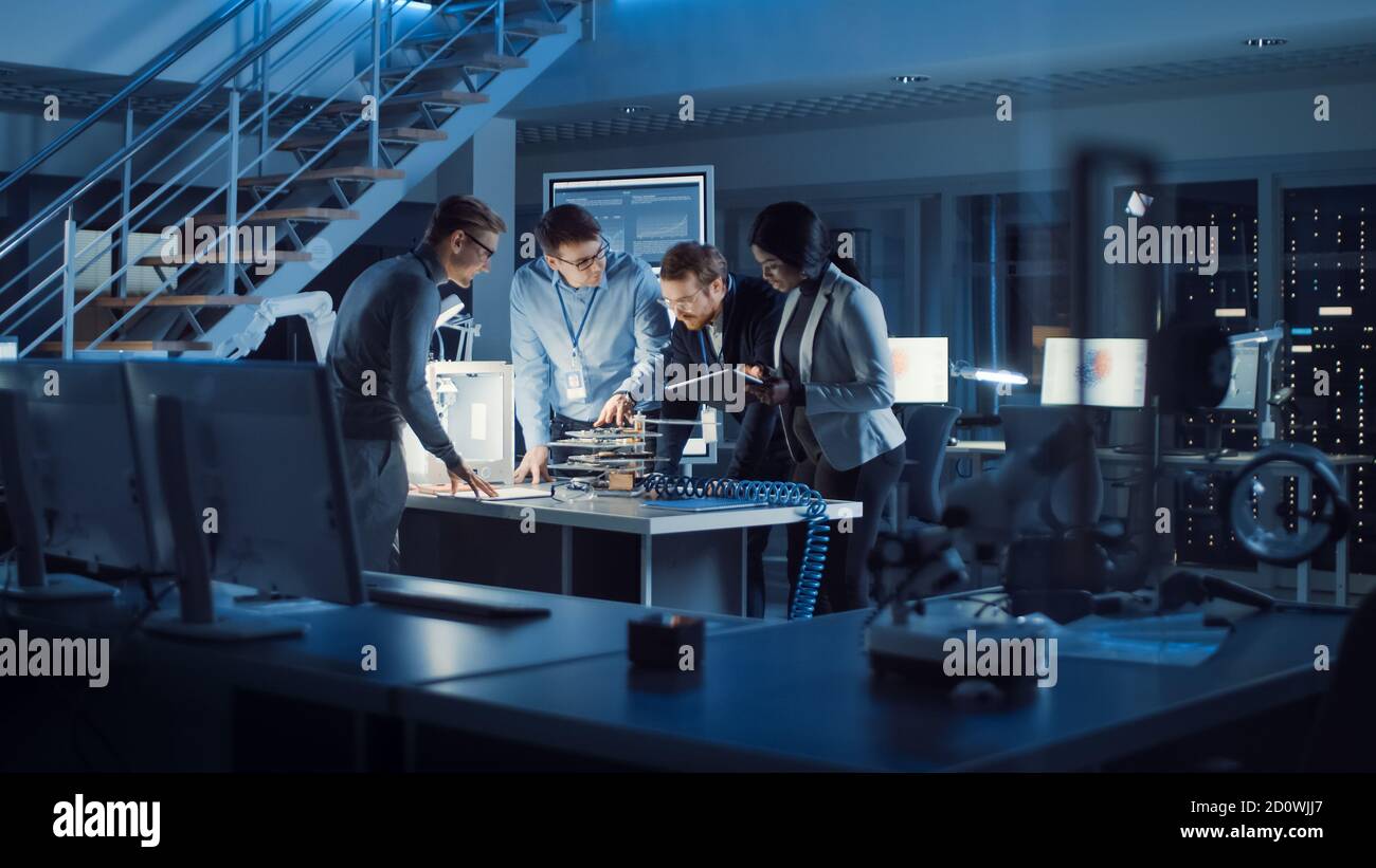 Team of Electronics Development Engineers Standing at the Desk with 3D ...