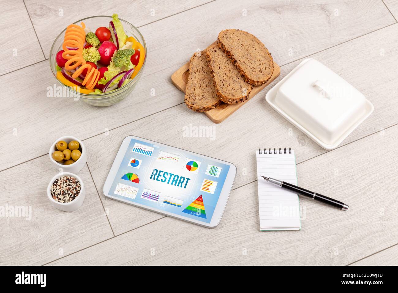 Organic food and tablet pc showing RESTART inscription, healthy ...
