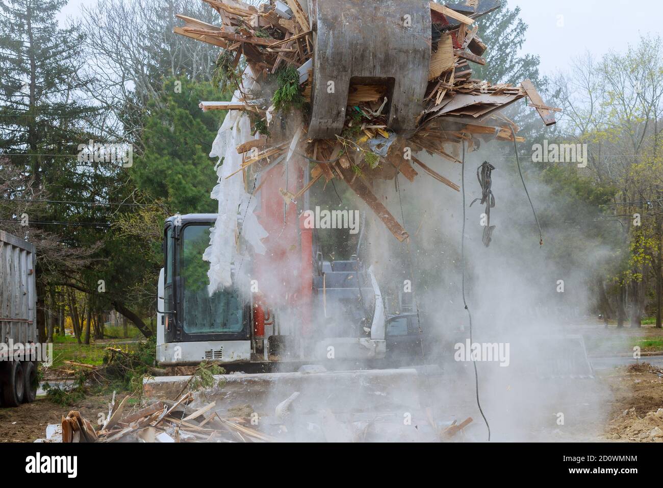 Excavator demolishing of the house after the hurricane urban ...